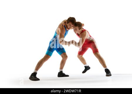 Young athlete man, wrestlers in blue and red uniform hand wrestling in ...