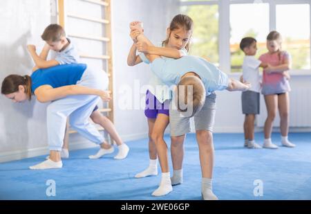 children are working on arm twists Stock Photo - Alamy