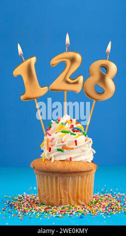 Birthday cupcake with candle number 128 - Coral fusion background Stock ...