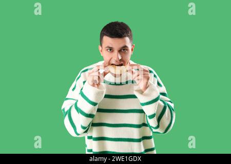 Young man eating pomelo on yellow background Stock Photo - Alamy