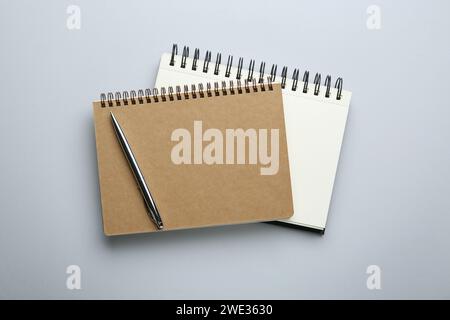 Notebooks on light grey background, top view. Space for text Stock ...