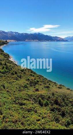 An aerial view of Lake Hawea surrounded by lush greenery. New Zealand ...