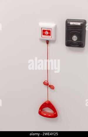 Red emergency pull cord in a disabled toilet Stock Photo - Alamy
