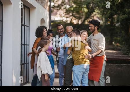 Diverse group of community members embracing successful community ...