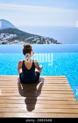 Tattooed woman looking away near railing on street in Prague,stock ...