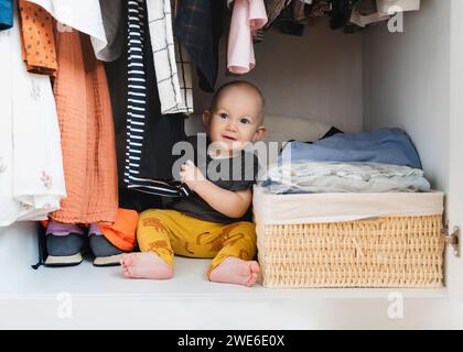 Cute baby boy playing with hanging toys arch on mat at home Baby ...