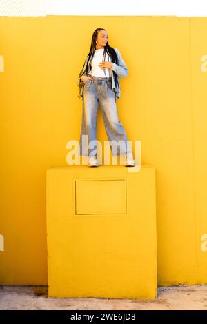 Young woman standing near concrete statue of Buddha in Phuket Stock ...