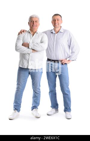 Mature brothers hugging on white background Stock Photo - Alamy