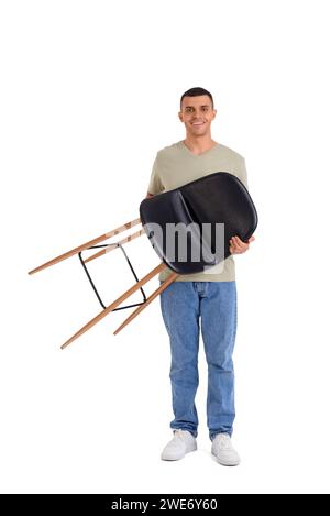 Young man carrying chair on white background Stock Photo - Alamy