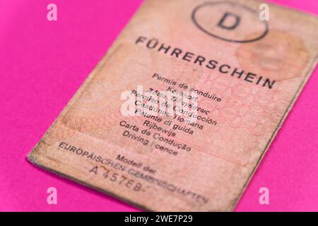 Pink old driving licence against a pink background Stock Photo - Alamy