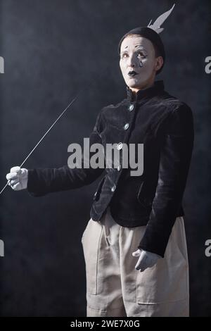 Vertical portrait of classic mime performer acting on stage in costume ...