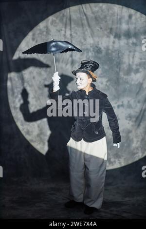 Vertical portrait of classic mime performer acting on stage in costume ...