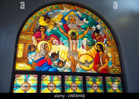 Colorful window with the image of the crucified Jesus and Mary crying ...