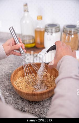 Hands pouring ingredients to make cookies at home Stock Photo - Alamy