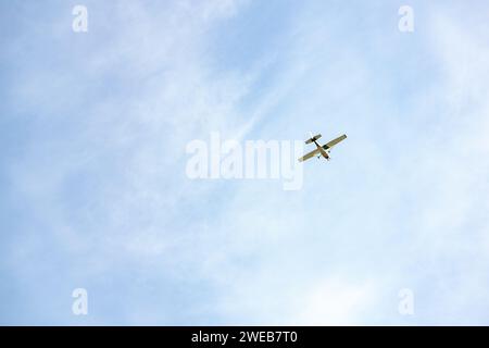 Single small airplane flying diagonal on the minimalist background of ...