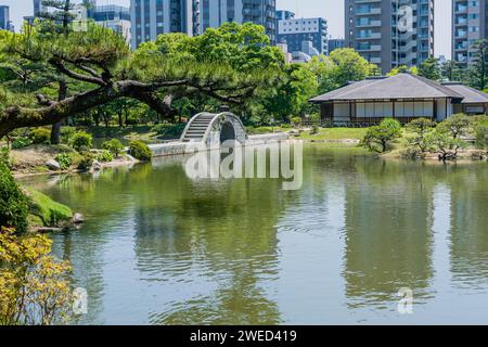 Concrete bridge across lake at Shukkeien Gardens in Hiroshima, Japan ...