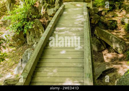 Shaded wooden footbridge in Japanese Shukkeien Gardens in Hiroshima ...