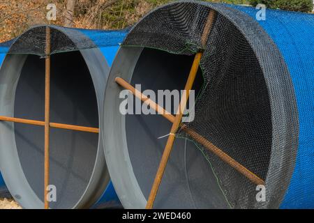 Large blue sections of steel industrial pipes sitting at construction ...