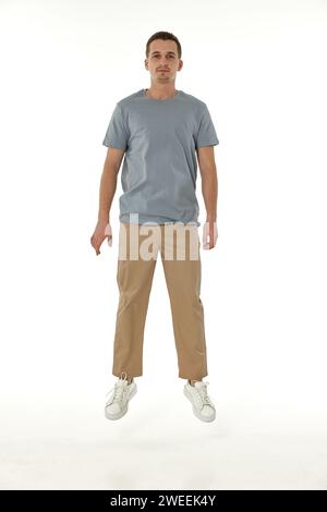Jump. Portrait of man in stylish modern clothes, oversized jeans, shirt ...