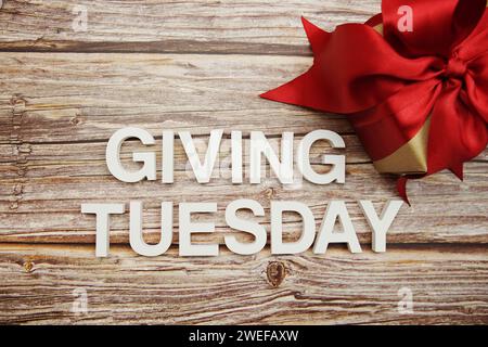 Giving Tuesday alphabet letters and gift box on wooden background Stock ...