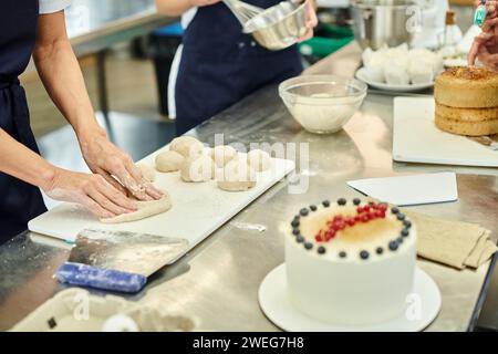 cropped view of chef in red apron hold knife isolated on white ...