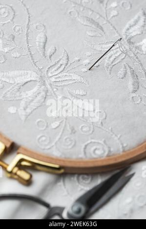 The process of hand embroidering a shirt with white threads on white ...
