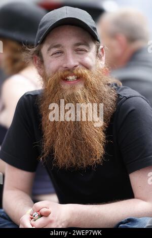 Handsome Irish redhead man with beard wearing casual sweater and ...