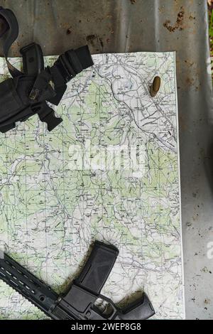 An array of military weapons, including rifles and pistols, is ...