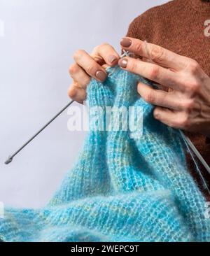 Close-up of hands knitting. Process of knitting. Hand made Stock Photo ...