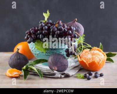 Blue grape, orange tangerine, figs fruit mix, healthy food background ...
