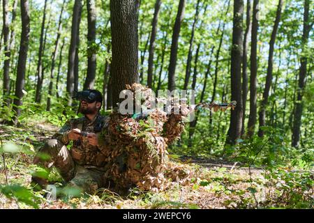 Skilled marksman in camouflage combat uniform, standing with sniper ...