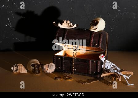 Old chest with treasures, seashells and skeleton on dark background ...