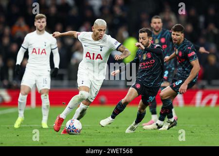 Richarlison of Tottenham Hotspur on the ball pressured by Michael ...