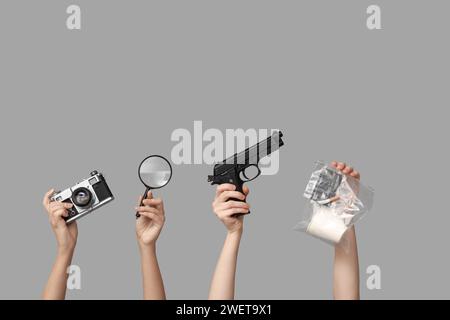 Women with accessories of detective and evidence on grey background ...