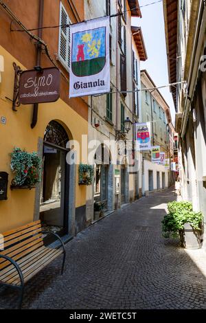 Banners honoring notable names of Lecco hang above the Via Alessandro ...
