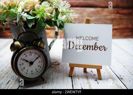 Welcome December text message with flower decoration on wooden ...