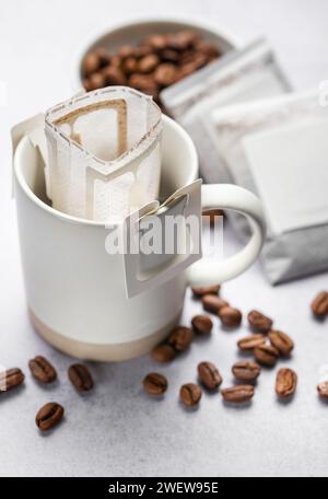 Instant freshly brewed cup of coffee from bag. Trendy variety of drip ...