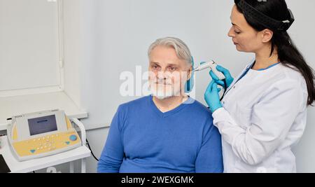 Senior man while tympanometry or impedance audiometry and test of ...