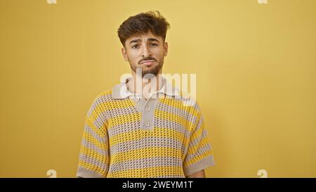 Stylish young arab man coolly bears his serious expression, standing ...