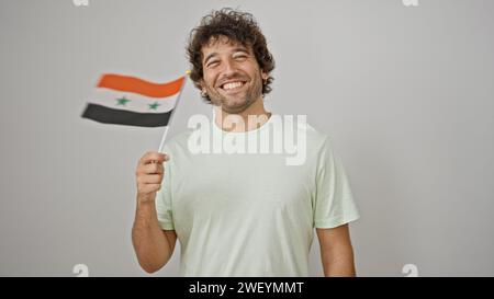 Handsome hispanic man holding syria flag screaming proud, celebrating ...