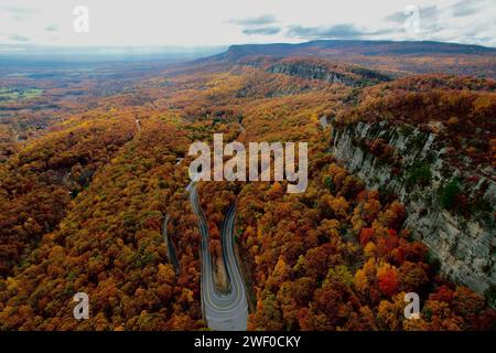 A scenic mountainous road winding between towering cliff Stock Photo ...