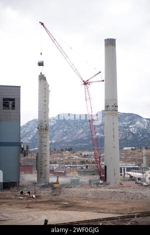 A crane takes down one of two smokestacks on the former coal burning ...