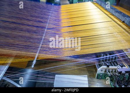 Modern Carpet weaving factory. Carpet making machine needle. Yarn ...