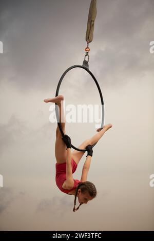 12 years old girl gymnast performing on aerial hoop outdoors Stock ...