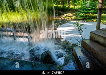 Passage under an artificial waterfall. Wall of water, falling cascade ...