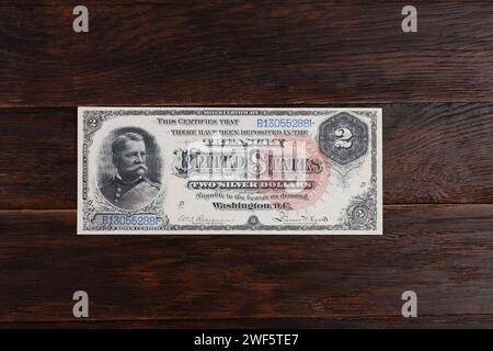 Old west period US 2 dollar banknotes on wooden background Stock Photo ...