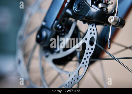 Part of the bicycle's braking system. Grey metal brake disc and brake ...
