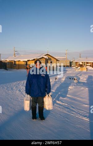 local resident of the Inupiat village of Kaktovik throws out old meat ...