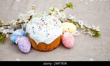 Festive cakes with white glaze, nuts and raisins with Easter eggs on ...