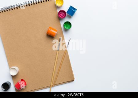 Album pages and paints, pencils, brush on a colored background. Top ...